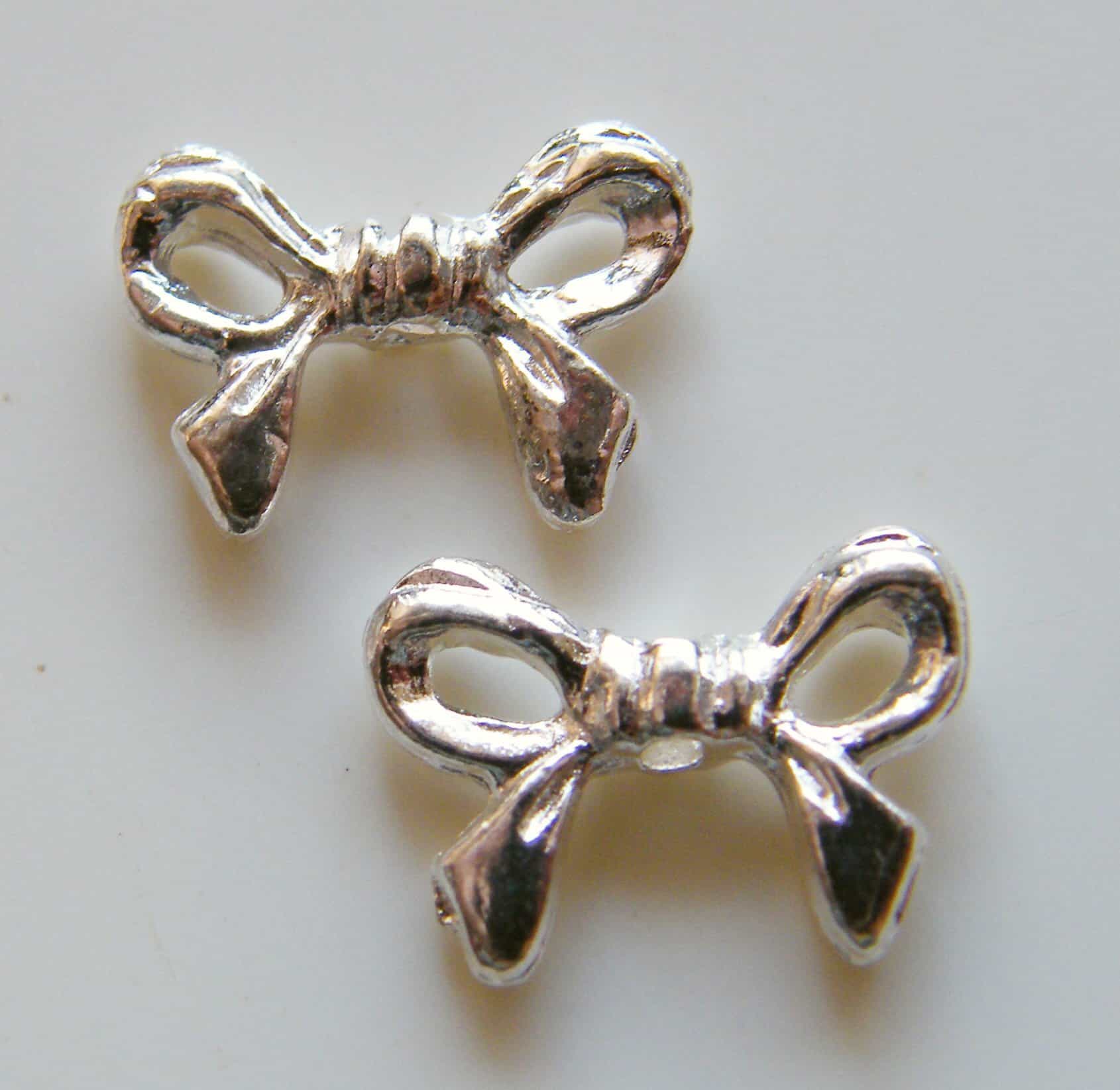 50pcs 14x10mm Metal Alloy Bow Spacer Beads – Bright Silver – BeadsForEwe